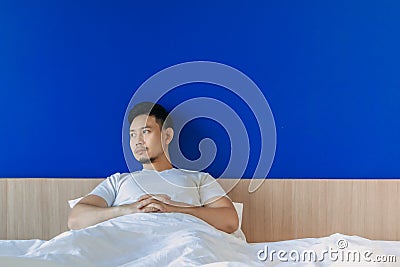 Serious And Grumpy Man Wake Up On The Bed On Blue Space Background ...