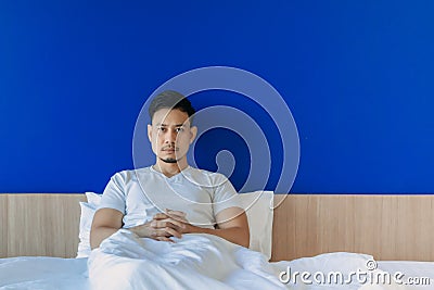 Serious And Grumpy Man Wake Up On The Bed On Blue Space Background ...