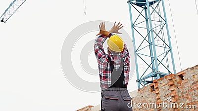 Serious Manager in Helmet and Uniform Giving Commands To Crane Operator ...