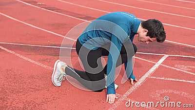 Side View of a Young Athlete Getting Ready for the Race on a Running ...