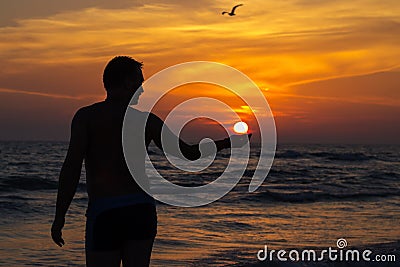 Silhouette Of A Man Holding The Sun Stock Photo - Image: 74957141