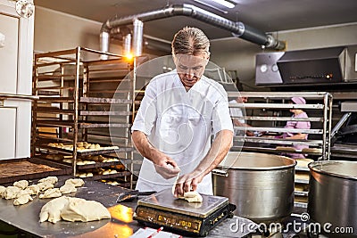 Skilled Man Baker Dividing Raw Dough Into Equal Portions And Weights ...