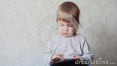 A Small Child Holding a Digital Tablet and Tapping the Screen of an ...