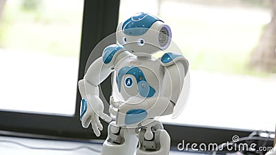 A Small Robot with Human Face and Body - Humanoid. Closeup of an Cute ...