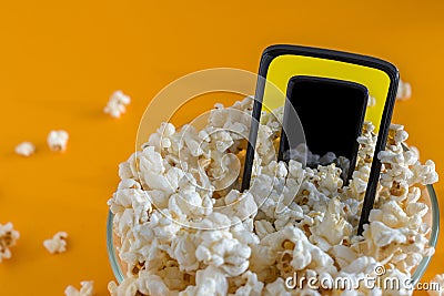 Smartphone And Popcorn On Yellow Background. Technology Concept. Cinema ...