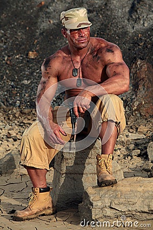 Soldier Sitting In Gravel Pit Stock Photo - Image: 16865550