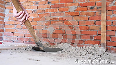 Spade Digging Sand in Front of Brick Wall. Professional Craftsmen Digs ...