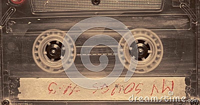 Stack of Cassettes and Spinning in Player. Cassette and Player. Stock ...