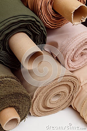 Stack Of Pastel Color Fabric Rolls Of Synthetic And Natural Fabrics ...