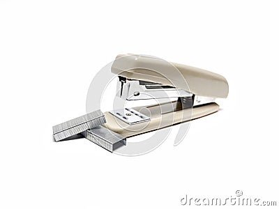 Staples Piled On White Paper Background Next To A Big Stapler Stock ...