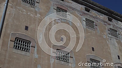 Stone Wall of a Prison Building with Prison Cell Windows with Metal ...