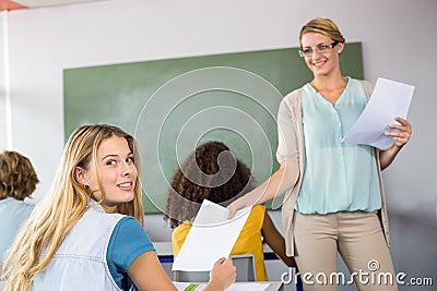 Teacher Handing Paper To Student In Class Stock Photo - Image: 50484488