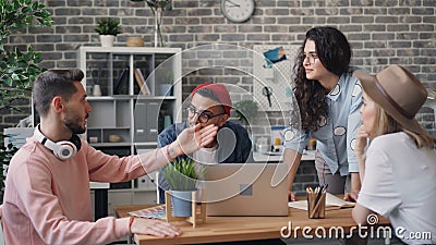 Team Members Talking and Gesturing Looking at Laptop Screen in Creative ...