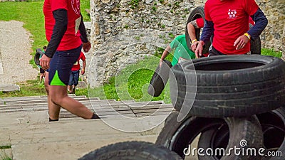 Team Running through Obstacle Course and Carrying Tires Stock Footage ...