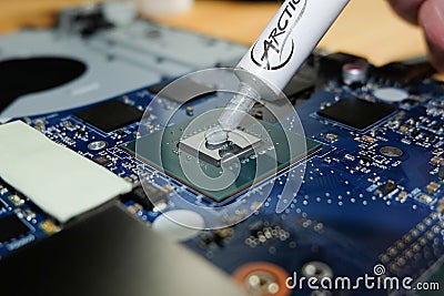 Technician Applying Thermal Paste To A Nvidia GPU On Laptop Motherboard ...