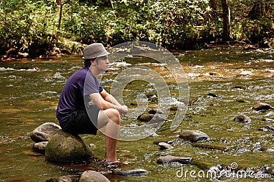 Teen Sitting On River Rocks, Side View Stock Photo | CartoonDealer.com ...