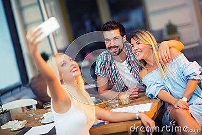 Three People Having Fun In Cafe Stock Photo | CartoonDealer.com #79984824