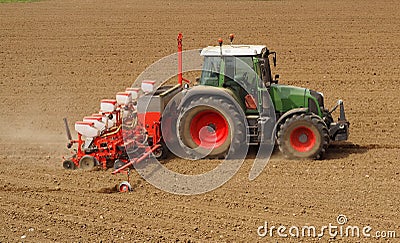 Tractor With A Modern Sowing Seeds Machine In A Newly Plowed Field In ...