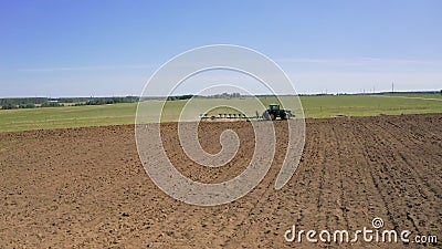 Tractor Plows the Field by Plow, Plowing Fields. Farmer Preparing the ...