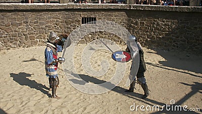 Two Armored Gladiators Making a Show with a Fight on Sandy Arena Real ...