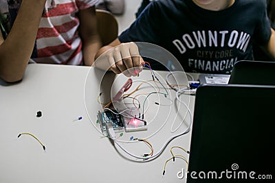 Two Children Build A Prototype Circuit With A Red Laser Controlled By A ...