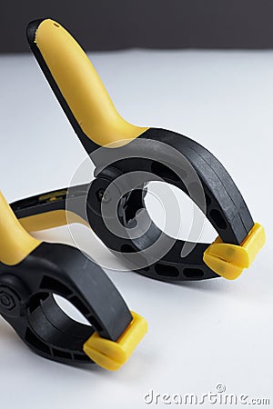 Two Construction Clips Of Different Sizes Of Black And Yellow Close-up ...