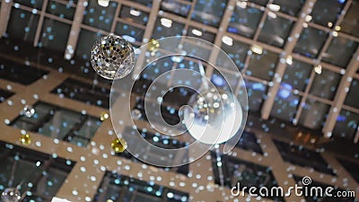 Two Mirrored Disco Balls are Suspended from the Ceiling Inside a High ...