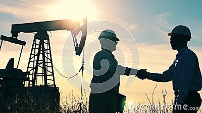 Two Oil Workers Shaking Hands in an Oilfield Stock Video - Video of ...