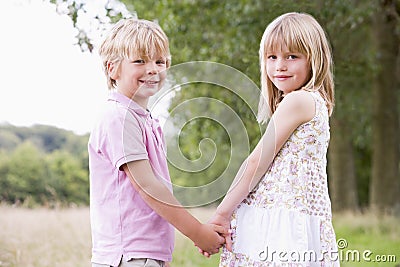 Two Young Children Standing Outdoors Holding Hands Stock Photography ...