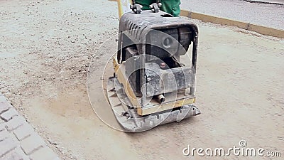 Vibrating Machine is Compacting Soil at the Construction Site. Stock ...