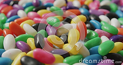 Video of Close Up of Multi Coloured Sweets Falling Over Blue Background ...