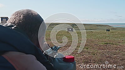 Back View of Unrecognizable Shooter Shooting into Target. Gun ...