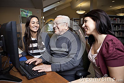 Volunteers Teaching A Senior How To Use A Computer Royalty Free Stock ...