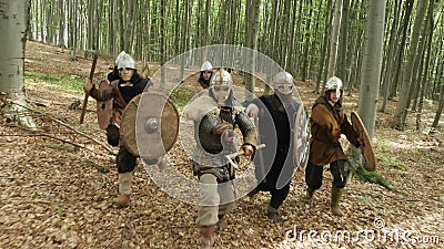 Warriors of Vikings are Running in the Forest on the Battle. Stock ...