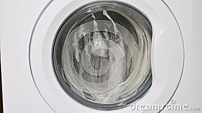 Washing Machine Door with Rotating Garments Inside. Focus in the Center ...
