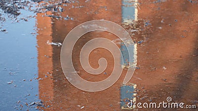 Water Reflection of Building Facade in Puddle with Ripples, after Rain ...