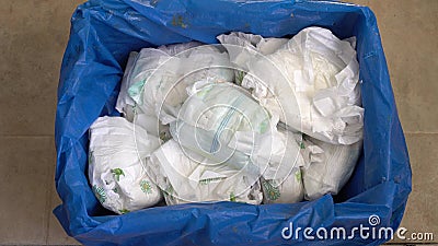 Wet and Dirty Disposable Diapers. Mother Throws the Used Diaper in the ...