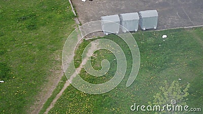 The Wind Blows Garbage from Garbage Cans Over the Grass in the ...