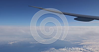 The Wing of an Airplane Flying Above Clouds Can Be Seen through the ...