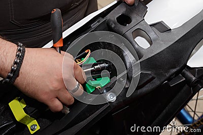 The Wizard Installs A New Battery On The Motorcycle After Refueling And ...