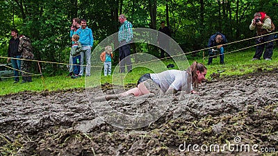 Woman Crawling through Mud As Part of Obstacle Course Stock Footage ...
