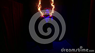 A Woman in the Guise of a Devil is Dancing with Fire Burning in Her ...