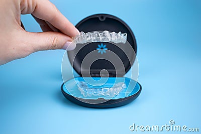 Woman Holding Invisalign Transparent Retainers With A Box On The Table ...