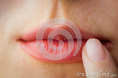 Woman Pointing To Her Lips Stock Photo - Image: 53065945