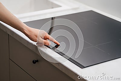 Woman Press Button On Control Panel At Modern Induction Stove Royalty ...