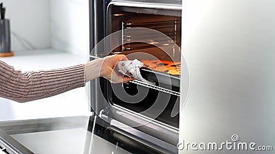 The Woman S Hands Open the Oven and Pull a Baking Sheet Out of the Oven ...