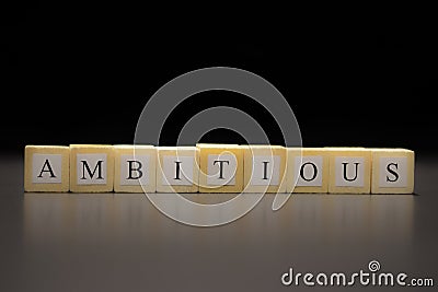 The Word AMBITIOUS Written On Wooden Cubes, Isolated On A Black ...