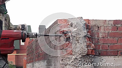 Worker Breaks Concrete at a Construction Site. Powerful Hammer Drill ...