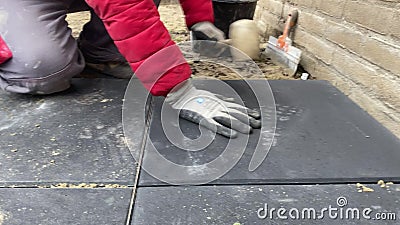 A Worker Laying Paving Slabs on the Street, Hitting Stone with Hammer ...