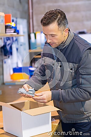 Worker Packaging Order For Metal Bolts Into Cardboard Box Royalty-Free ...